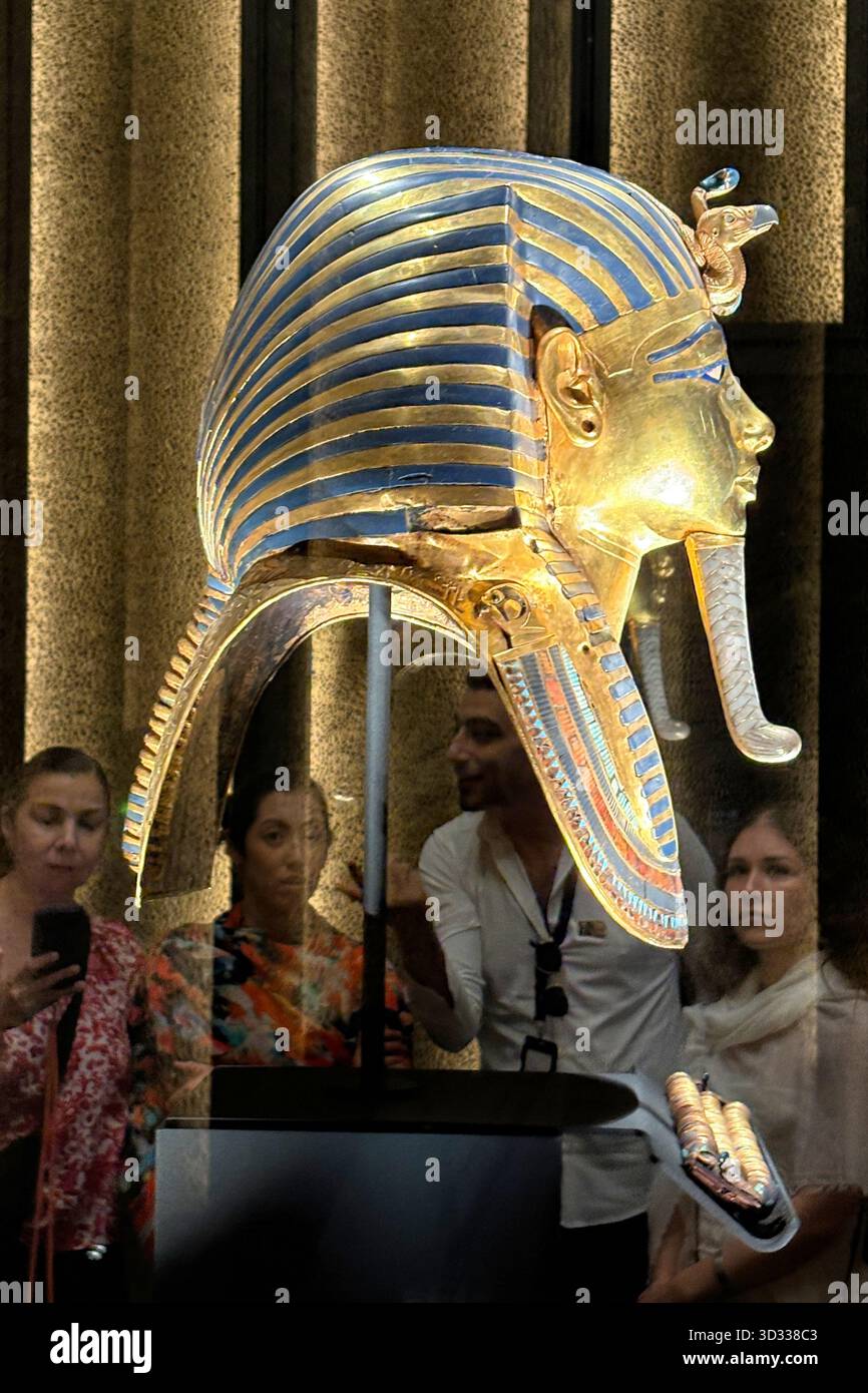 Tourists view the golden burial mask of King Tutankhamun during the first day for visitors after ...