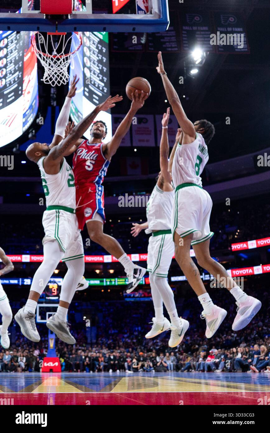 Philadelphia 76ers' Quentin Grimes, center left, goes up for the shot ...