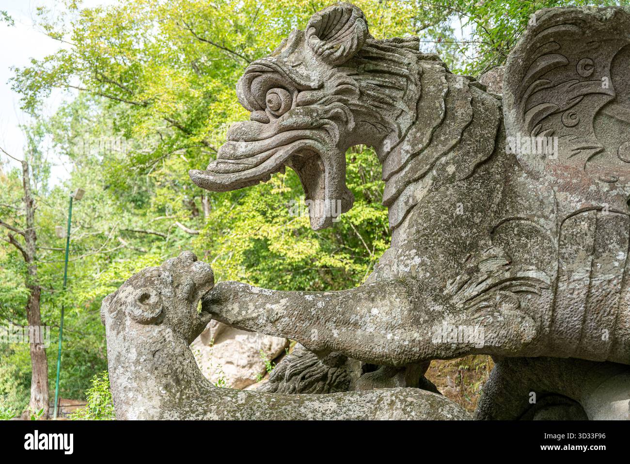 Italy - Bomarzo - Sacro Bosco - Dragon battling a lion, close view of ...