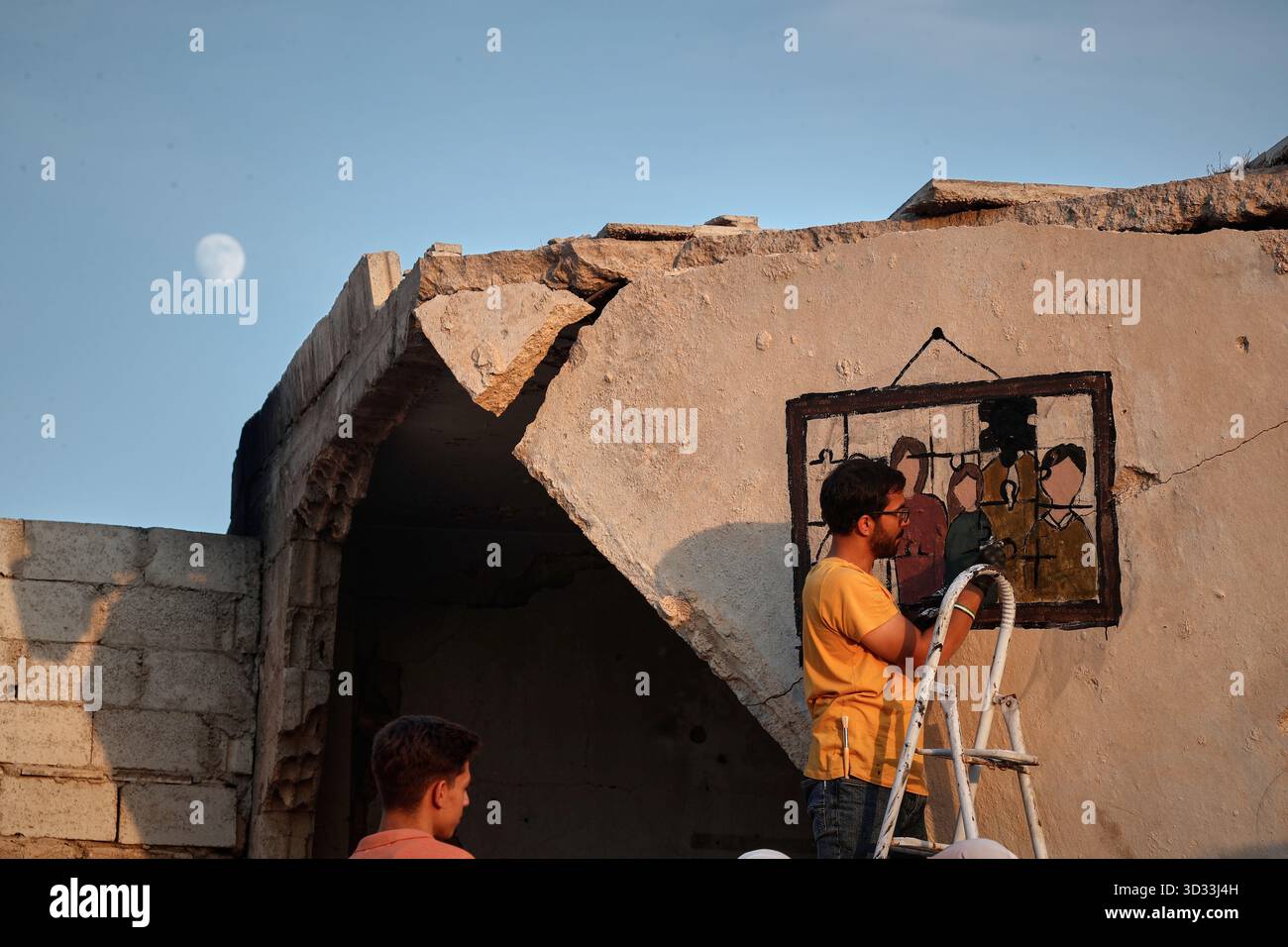 A Syrian graffiti artist paints on the collapsed ceiling of a war ...