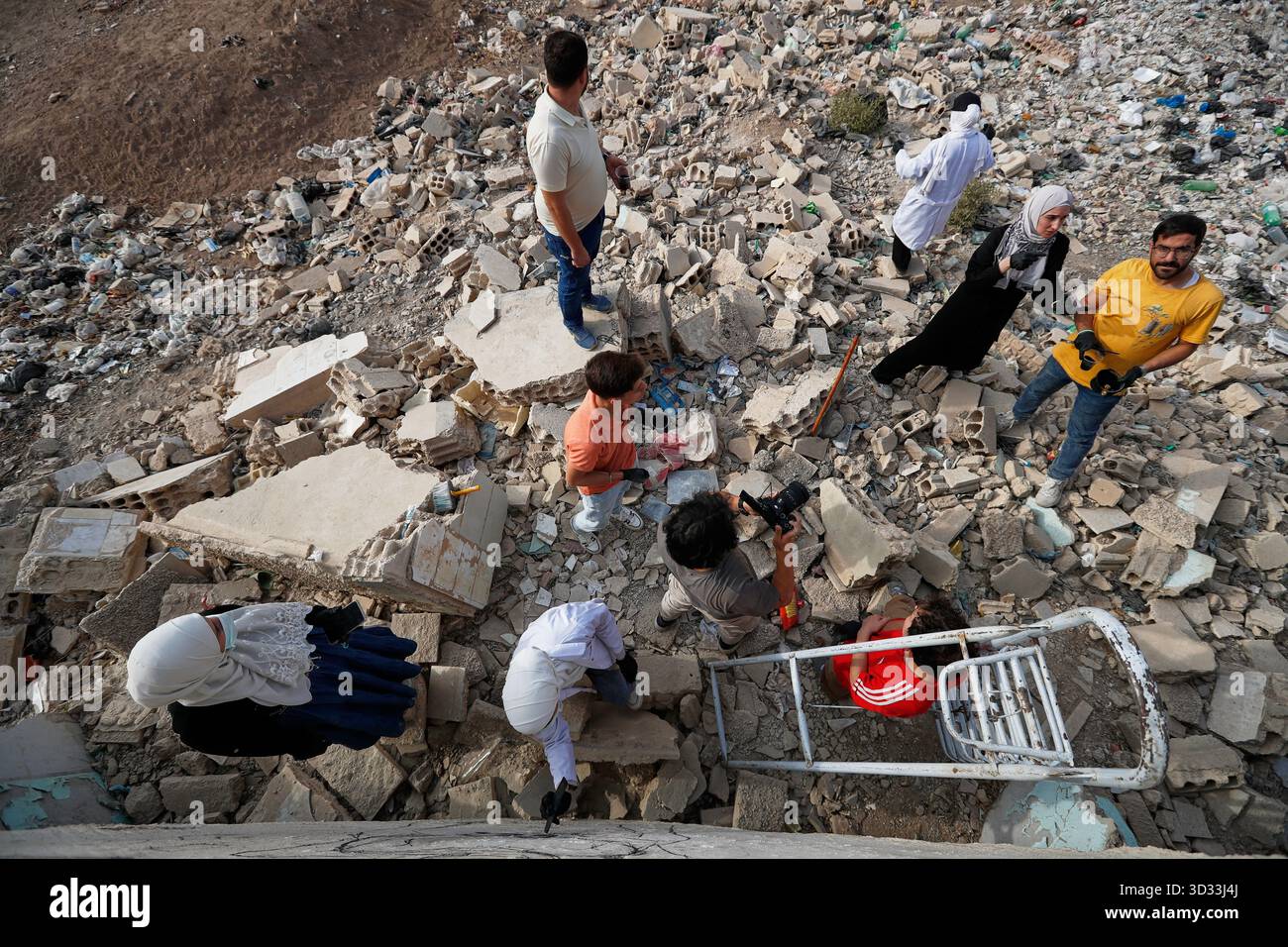 A group of Syrian graffiti artists look at a mural they painted on the ...