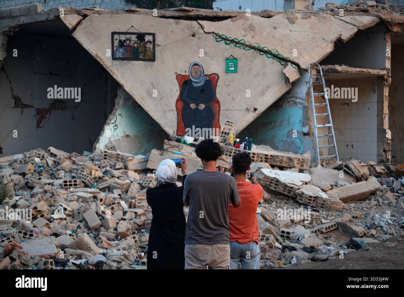 A group of Syrian graffiti artists take photos of the murals they just ...