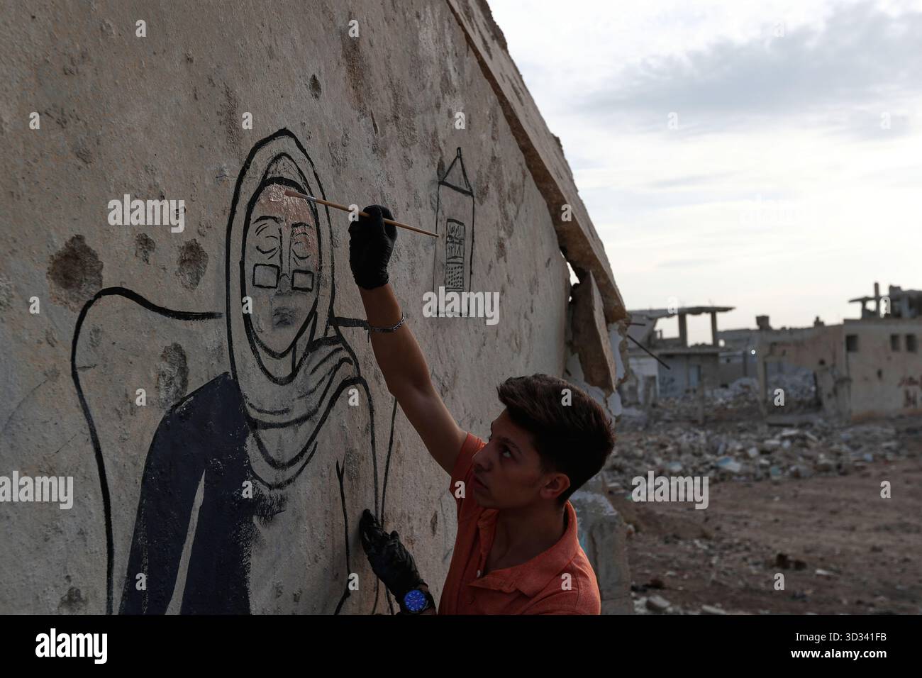 A group of Syrian graffiti artists paint a mural on the collapsed ...