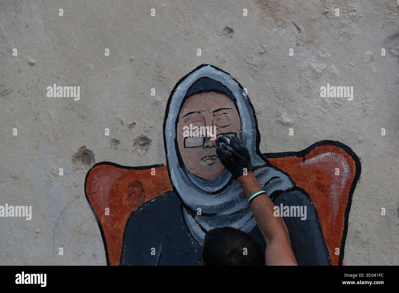 A group of Syrian graffiti artists paint a mural on the collapsed ...