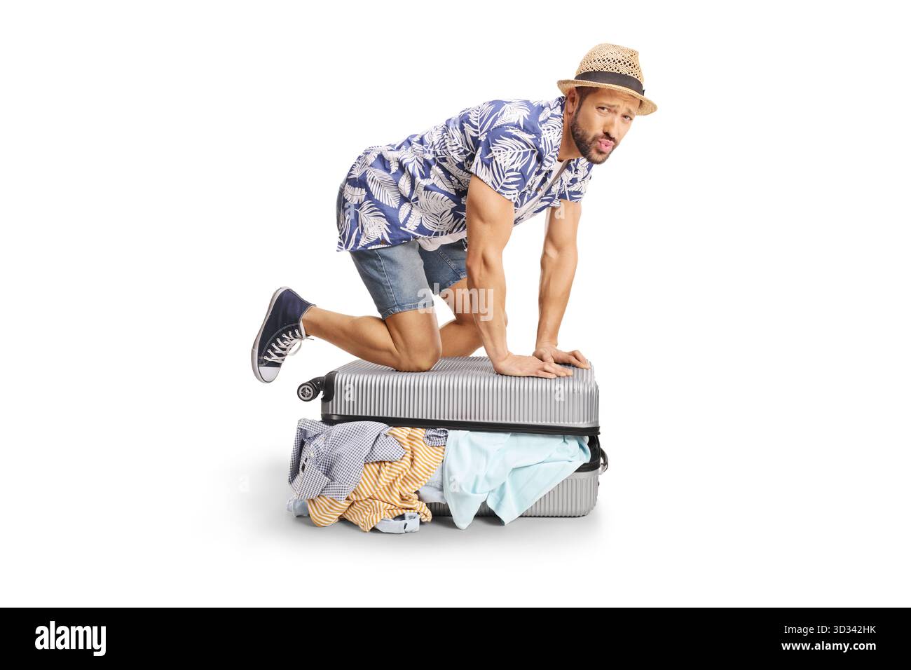 Man trying to close overpacked suitcase isolated on white background ...