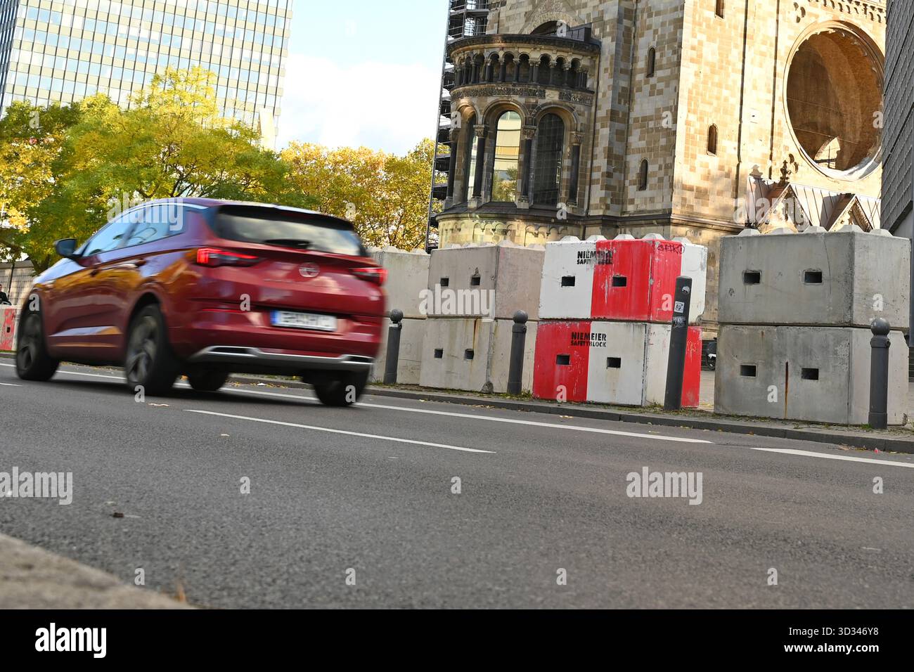 PRODUCTION - 03 November 2025, Berlin: A car drives past stacked ...