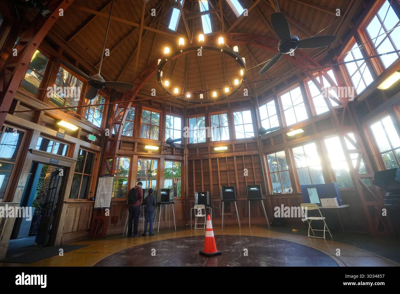 Daniel Atkins votes as his won watches at the Sunnyside Conservatory on ...