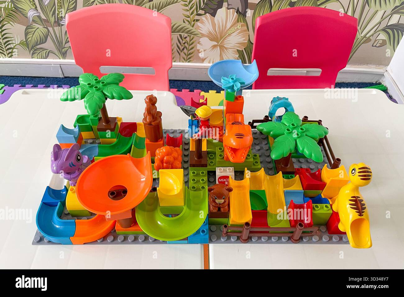 Parts of colored children construction set are in play table, toys in ...