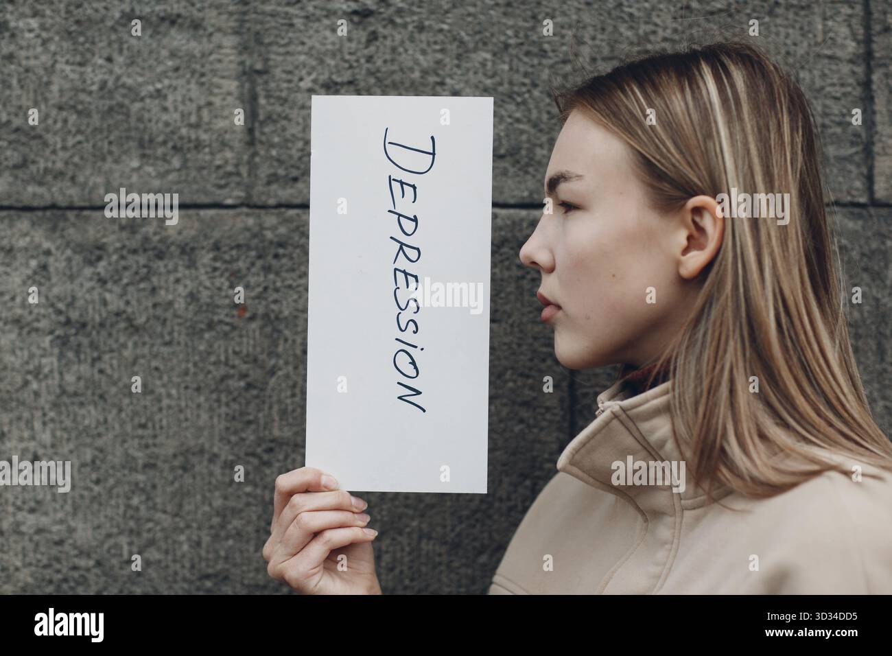 Woman holding white sheet paper labeled word Depression in hand Stock ...