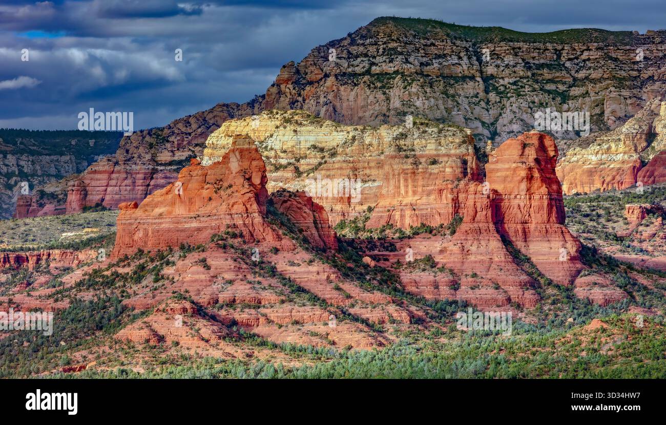 Red sandstone cliffs and sculpted buttes rise above juniper–pinyon ...