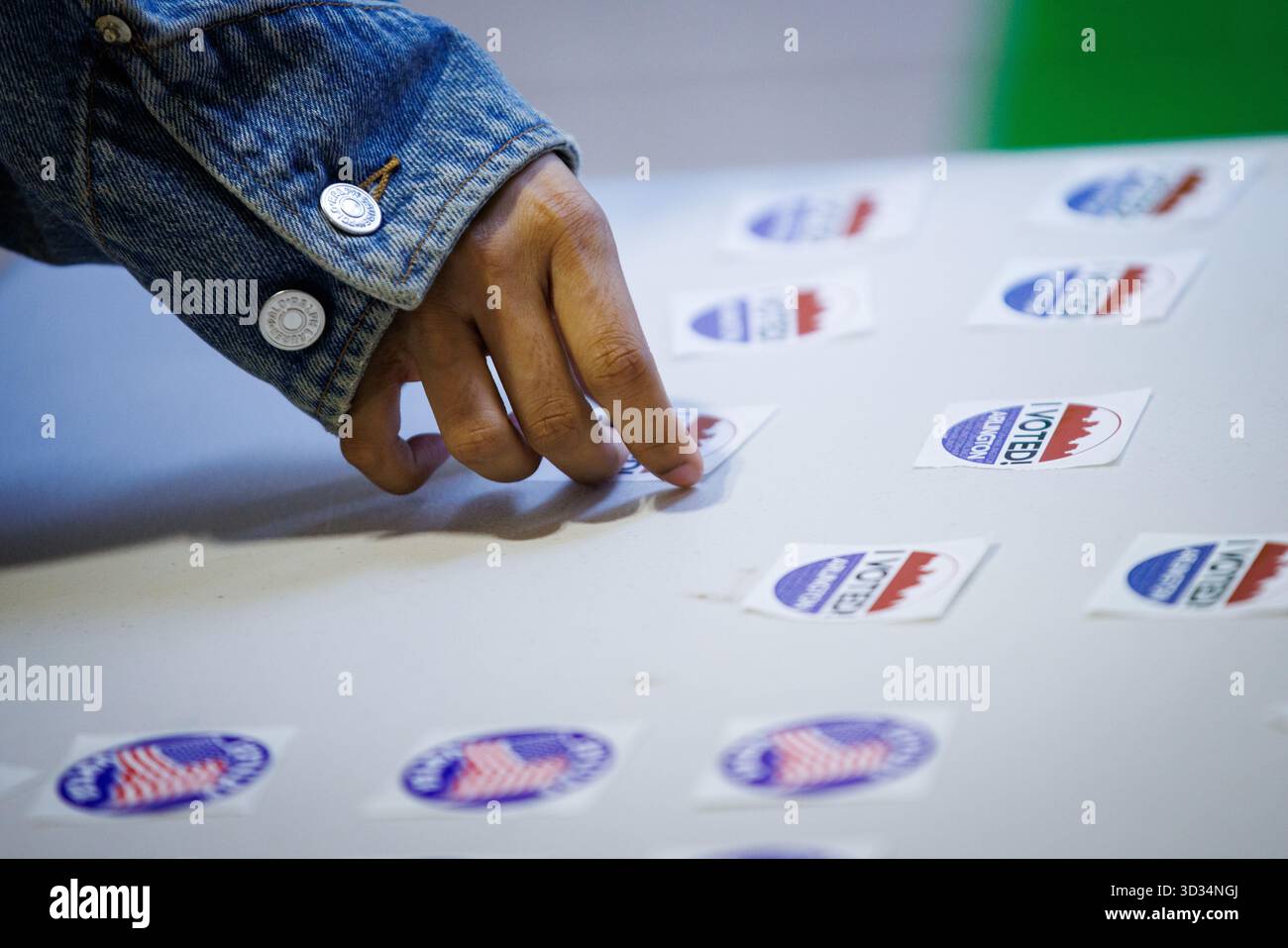 A voter picks up an “I Voted!” sticker after casting their ballot for ...