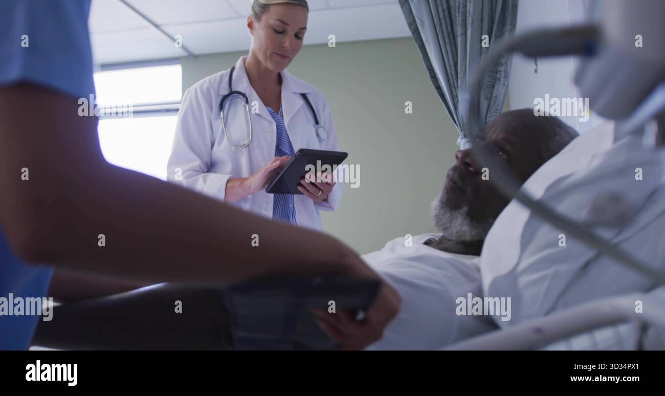 Nurse in scrubs and doctor assessing patient vital signs in hospital ...