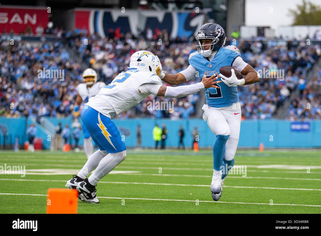 Tennessee Titans wide receiver Elic Ayomanor (5) stiff arms Los Angeles ...