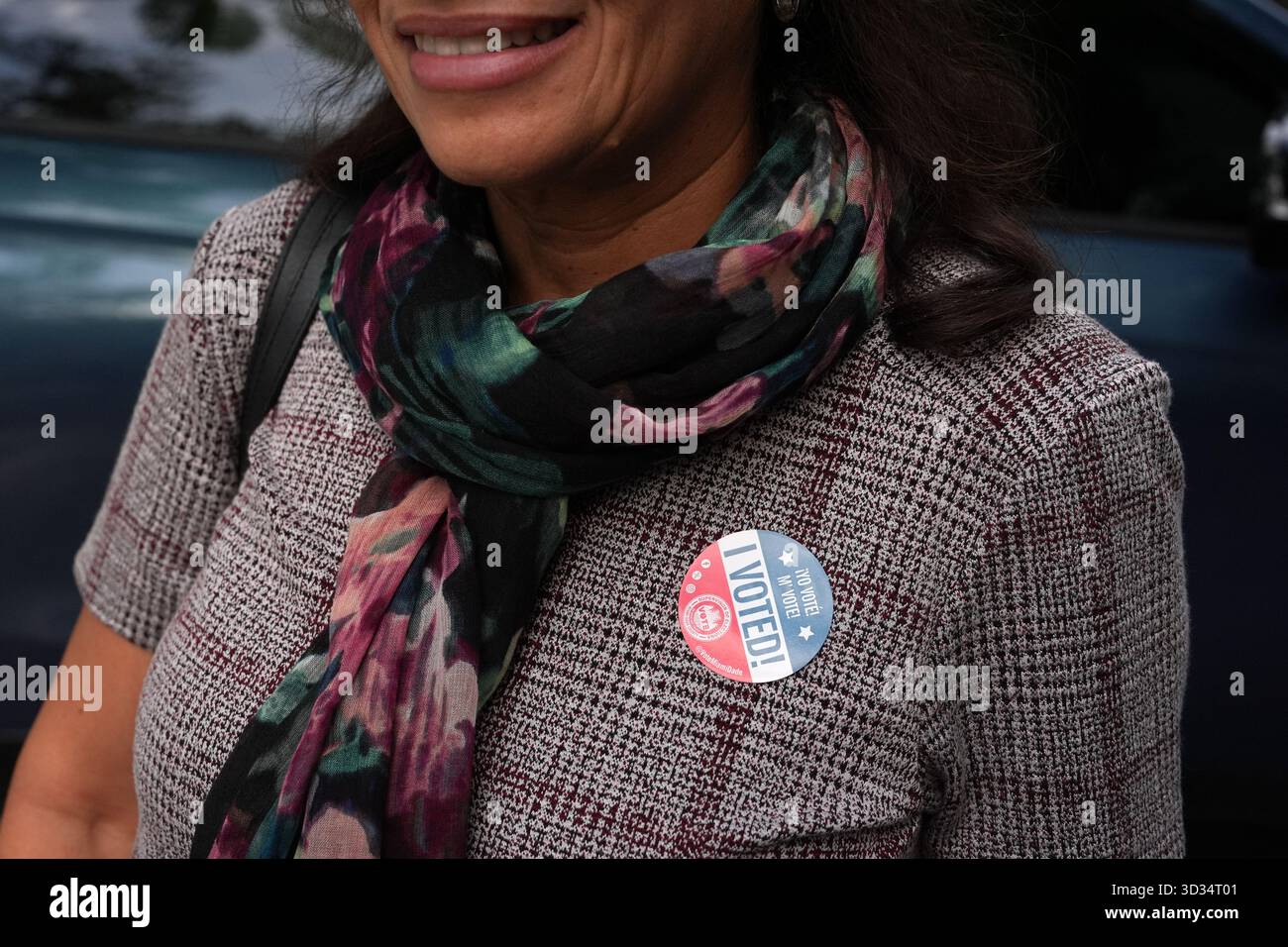 A Voter Wears An I Voted Sticker As She Leaves A Polling Place After