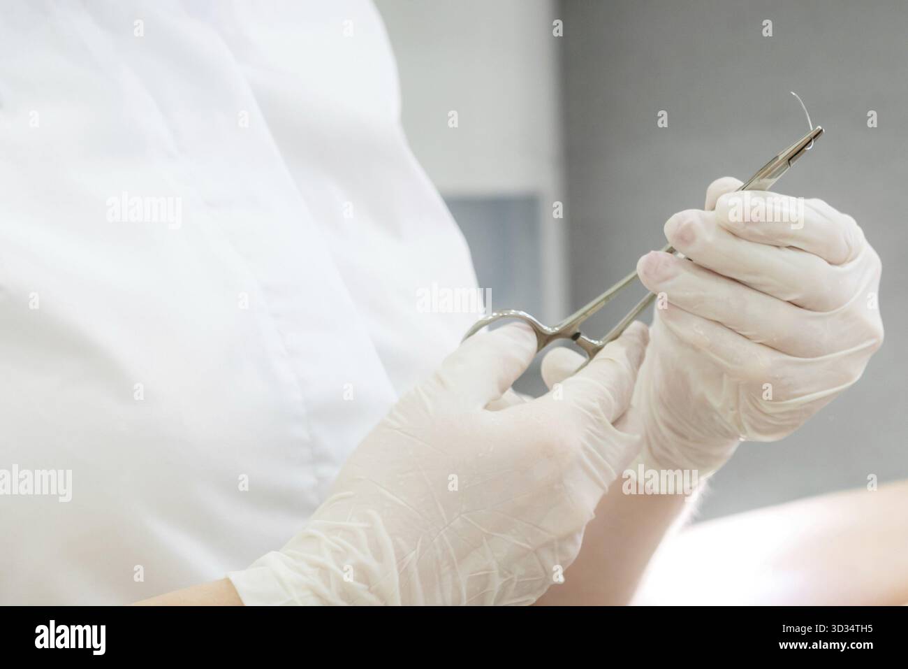 Surgical forceps holding suture hi-res stock photography and images - Alamy