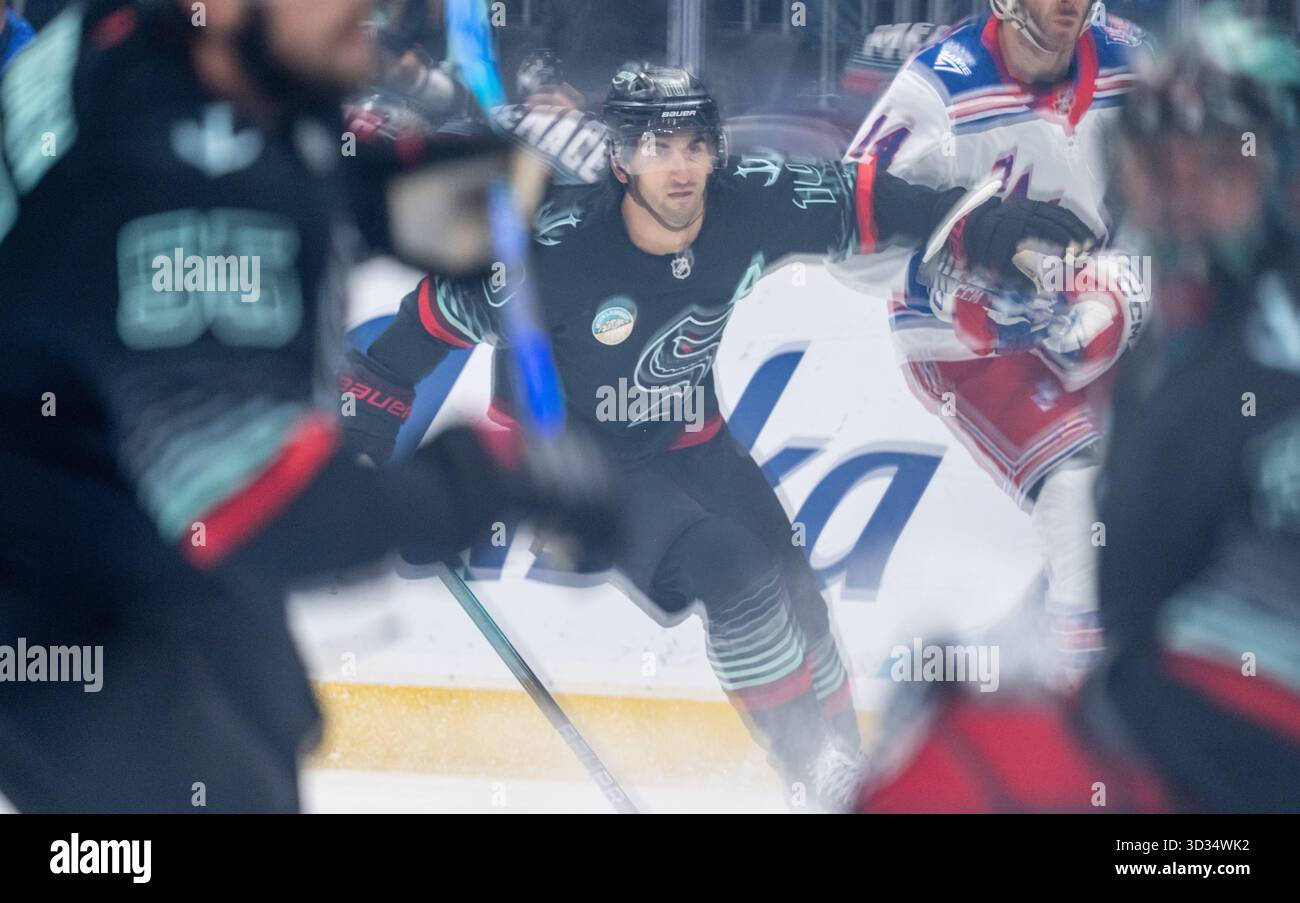 Seattle Kraken forward Matty Beniers is pictured through the glass ...