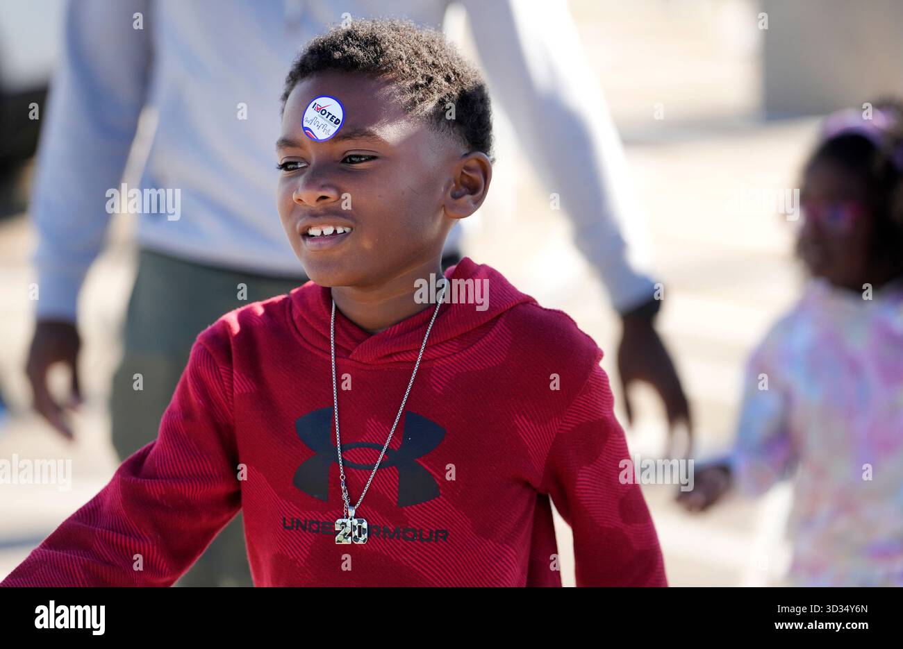 Earnest Porter Jr., 7, wears a voting sticker after he and his sister ...