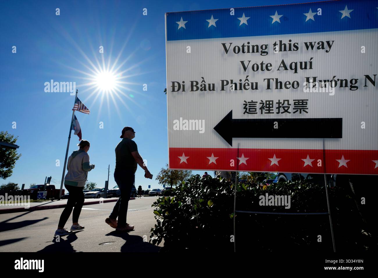 People are shown outside the polling place at the Richard & Meg Weekley ...