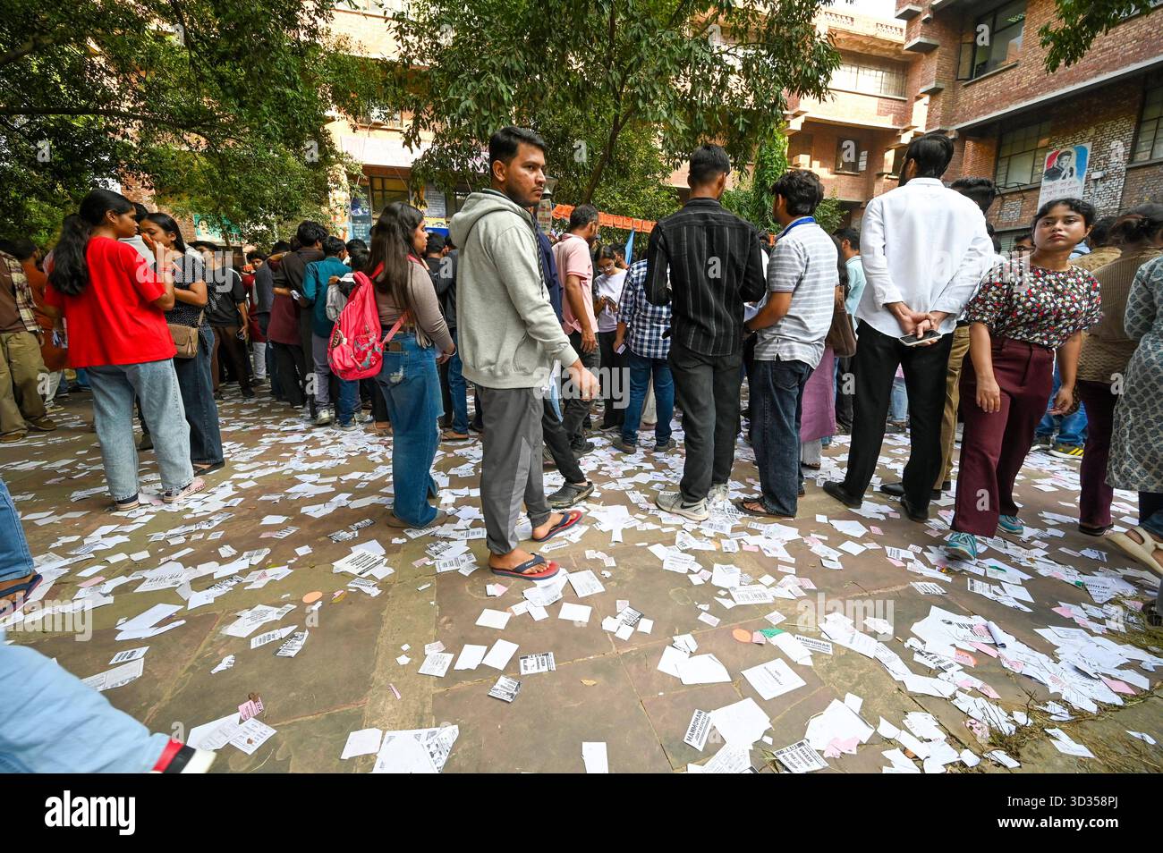 NEW DELHI, INDIA - NOVEMBER 4: Students stand in queue to cast their ...