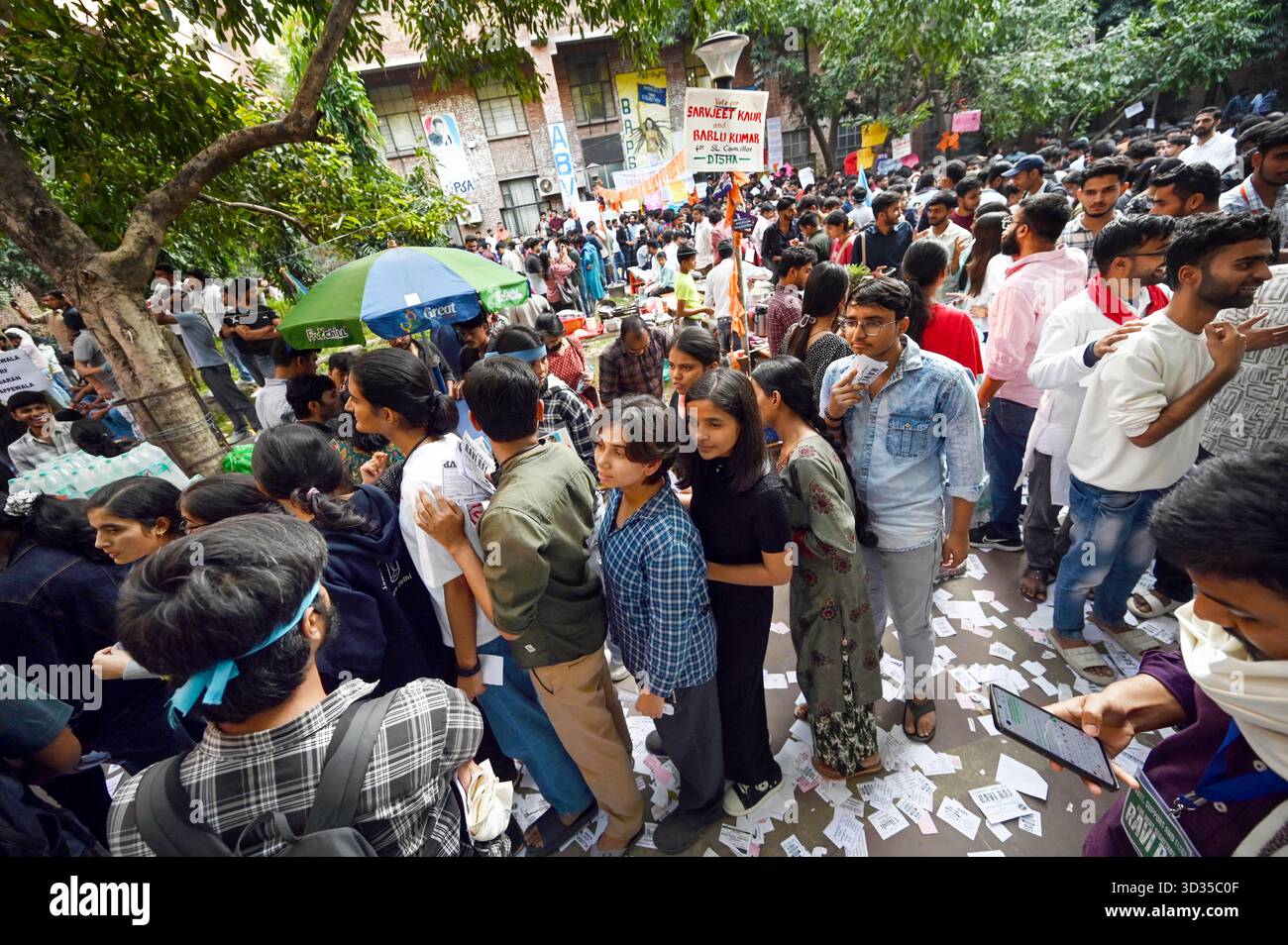 NEW DELHI, INDIA - NOVEMBER 4: Students stand in queue to cast their ...