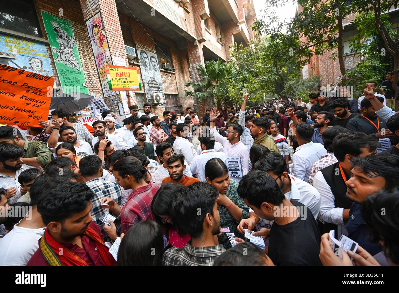 NEW DELHI, INDIA - NOVEMBER 4: Students stand in queue to cast their ...