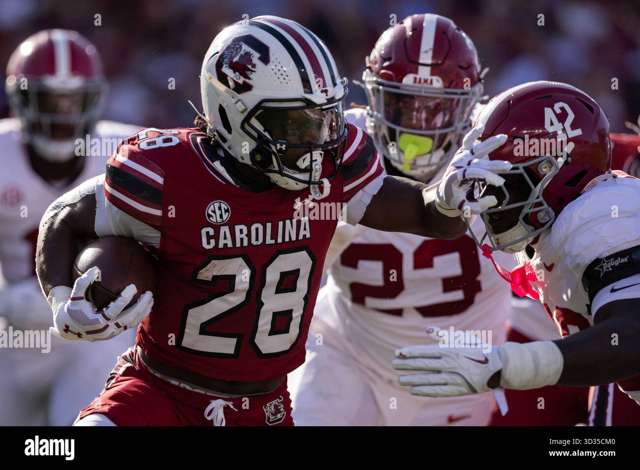 South Carolina running back Matt Fuller (28) stiff arms Alabama ...