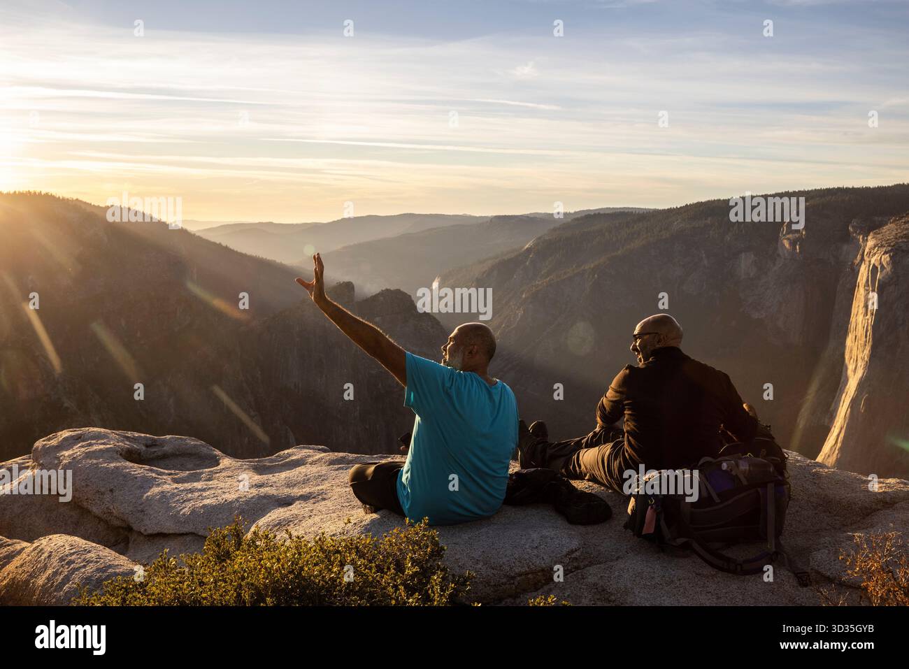 Visitors watch a sunset on rock ledge near Taft Point amidst the ...