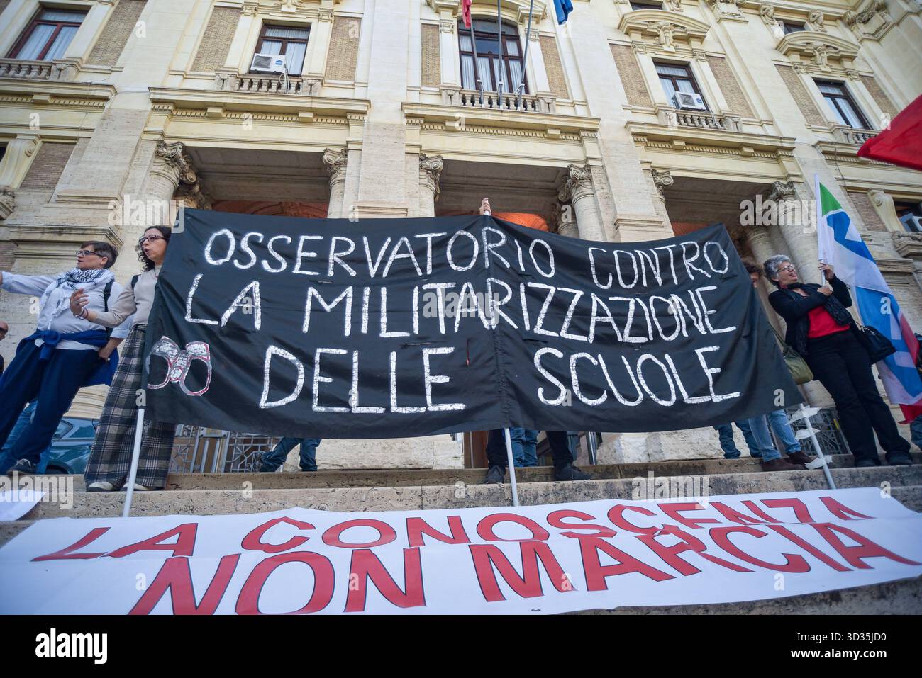 Banners are displayed during the "Schools Don't Enlist" protest ...