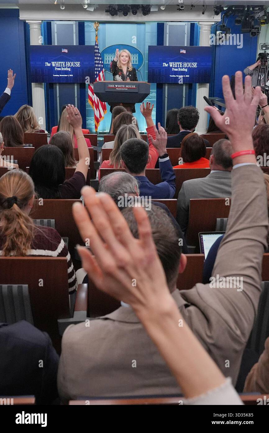 Reporters raise their hands to ask questions as White House press ...
