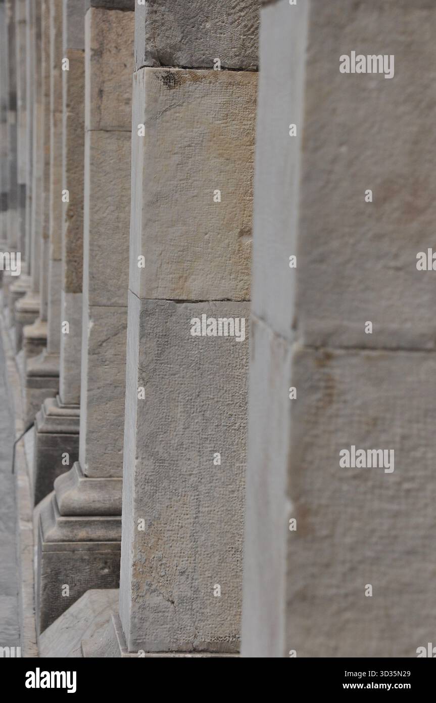 These stone columns create a strong visual line along a walkway ...
