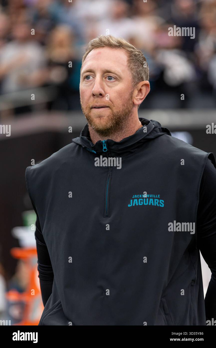 Jacksonville Jaguars head coach Liam Coen stands for the national ...