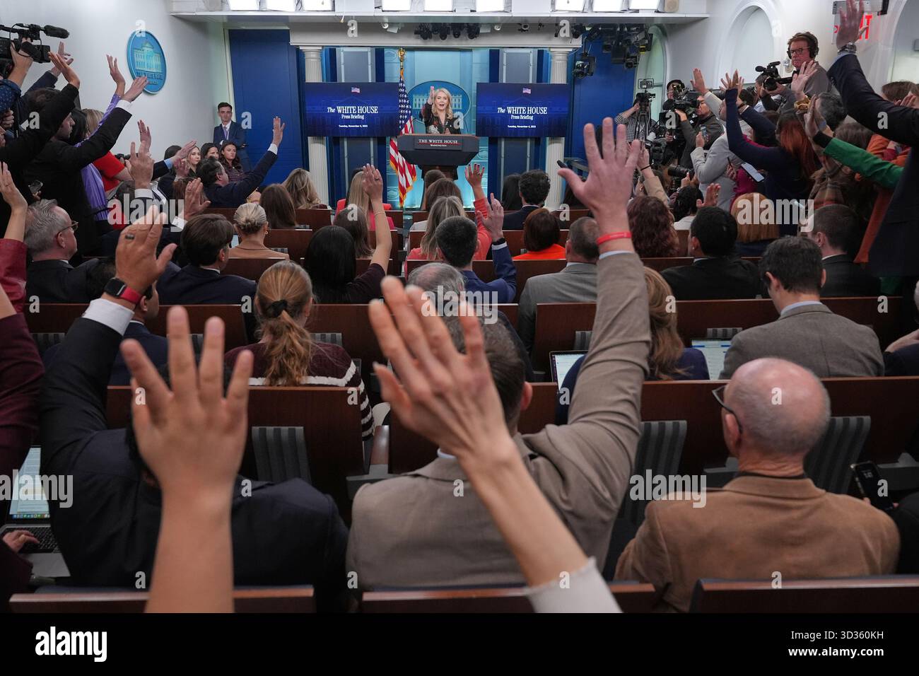 Reporters raise their hands to ask questions as White House press ...