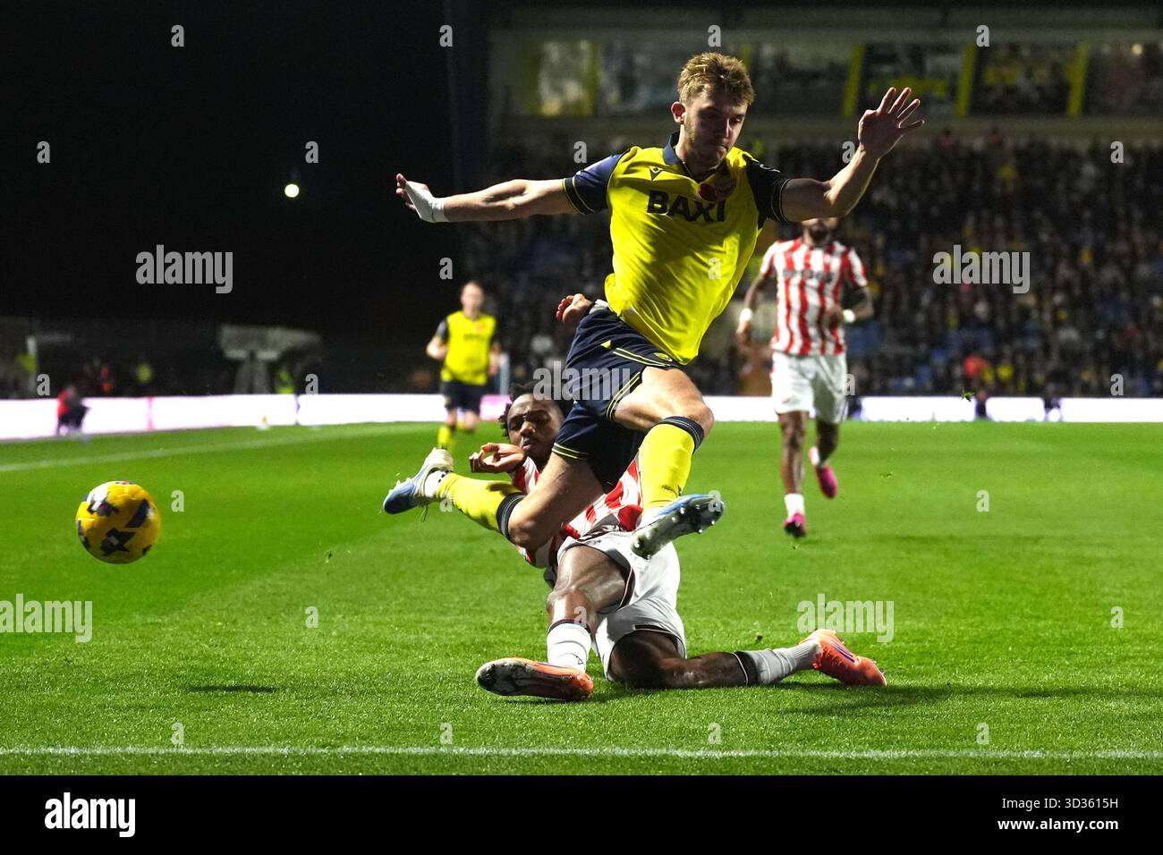 Stoke City's Eric Bocat (right) tackles Oxford United's Stanley Mills ...