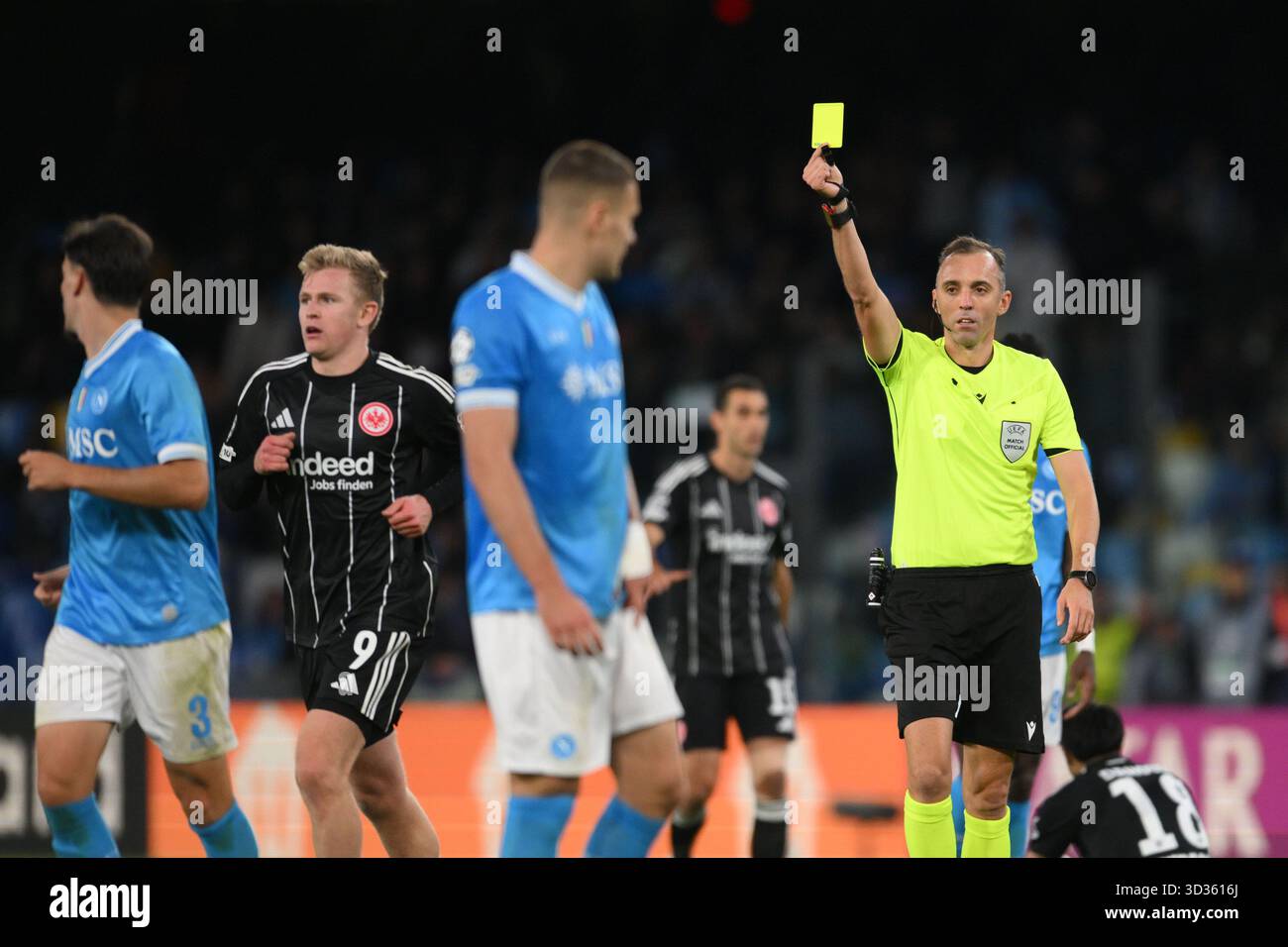 referee Joao Pinheiro issues a yellow card to Miguel Gutierrez of SSC ...