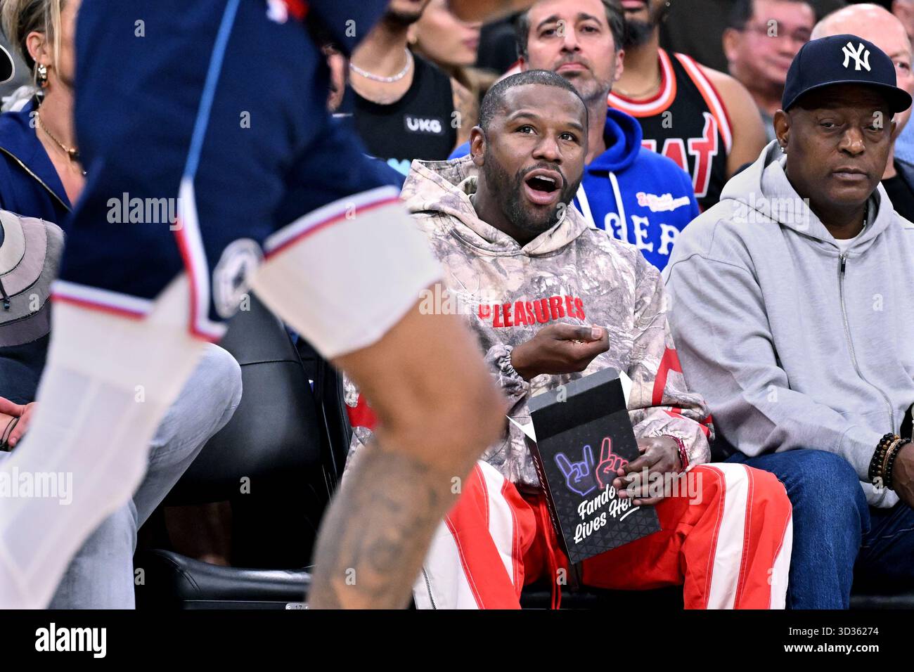Boxer Floyd Mayweather Jr. sits court side during a game between the ...