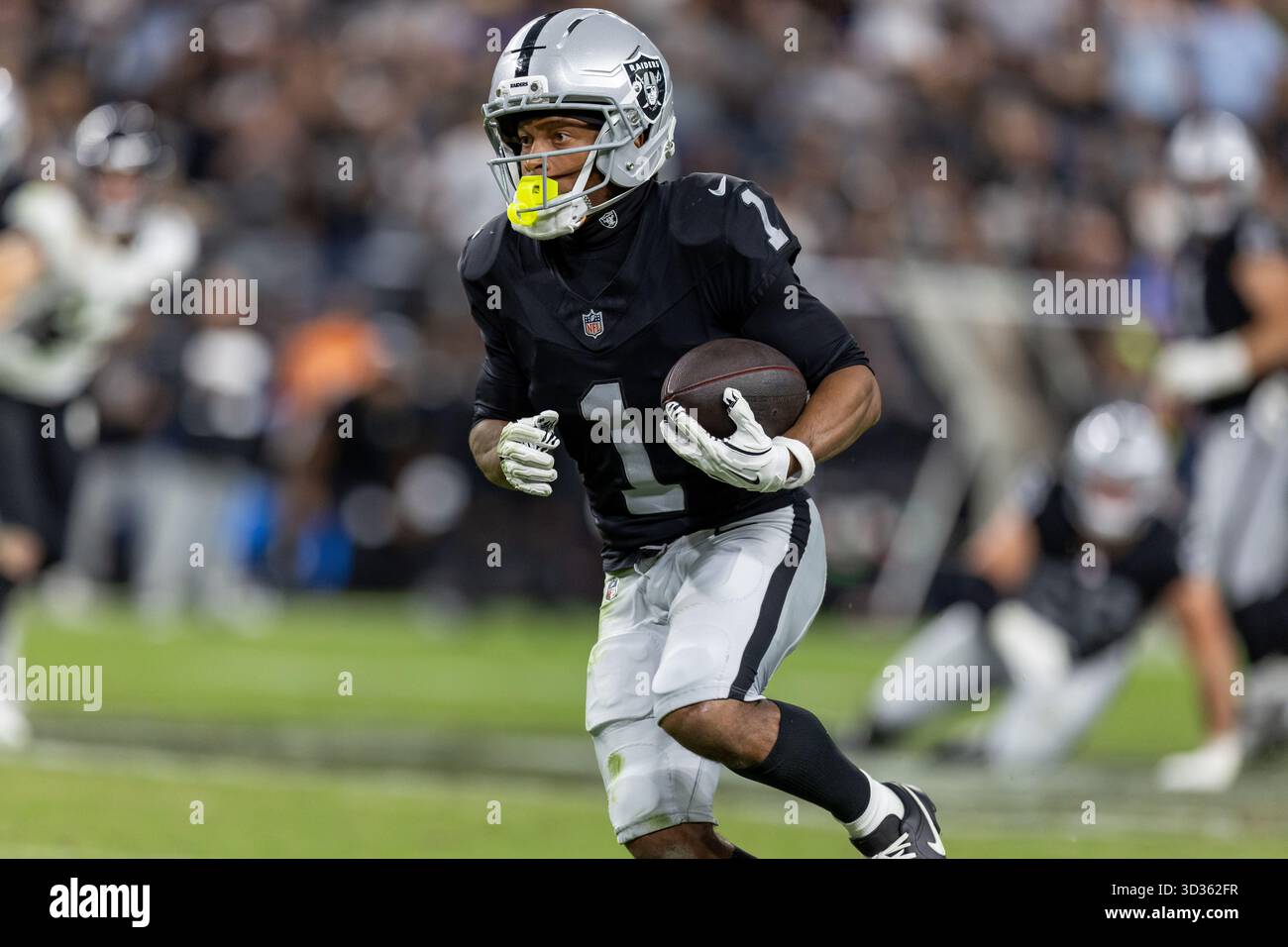Las Vegas Raiders wide receiver Tre Tucker (1) catches a pass and runs ...