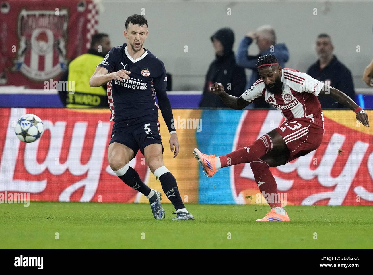 Olympiacos' Rodinei kicks the ball past PSV's Ivan Perisic during a ...