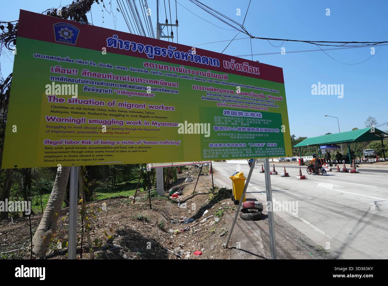 FILE - A sign near military checkpoint warns in Thai, English and ...