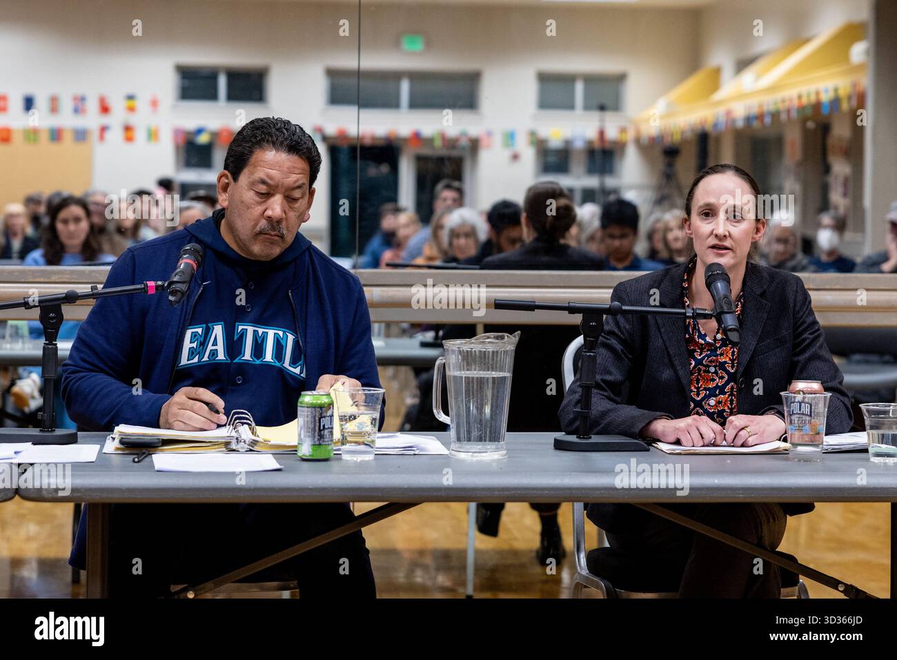 Seattle mayor Bruce Harrell, left, listens as mayoral candidate Katie ...