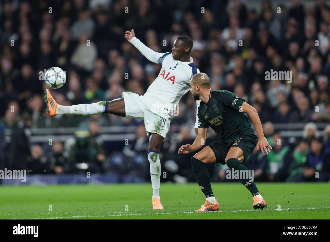 Randall Kolo Muani of Tottenham Hotspur controls the ball while ...