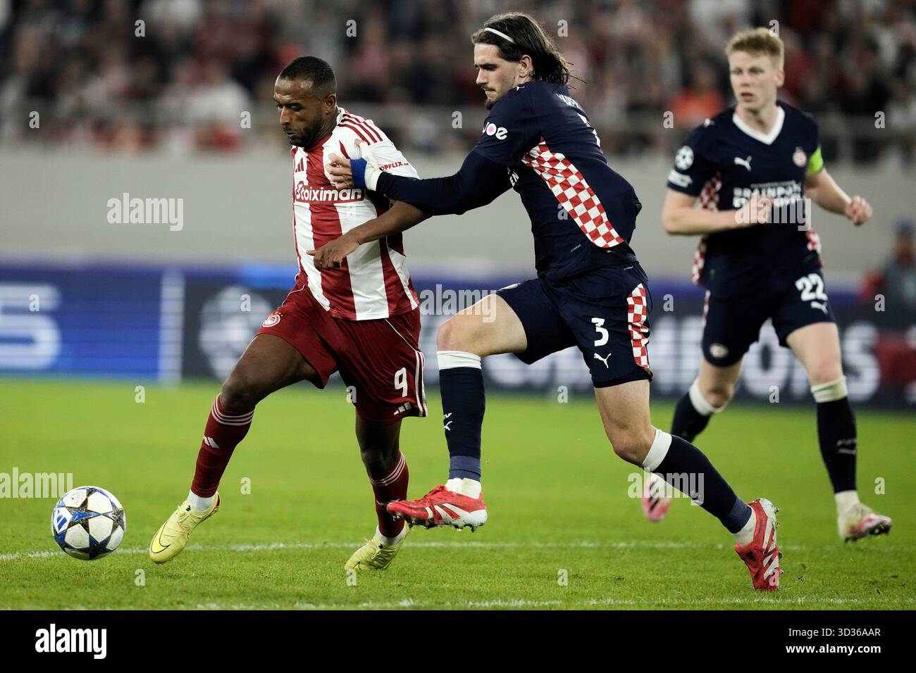 Olympiacos' Ayoub El Kaabi, left, is challenged by PSV's Yarek ...