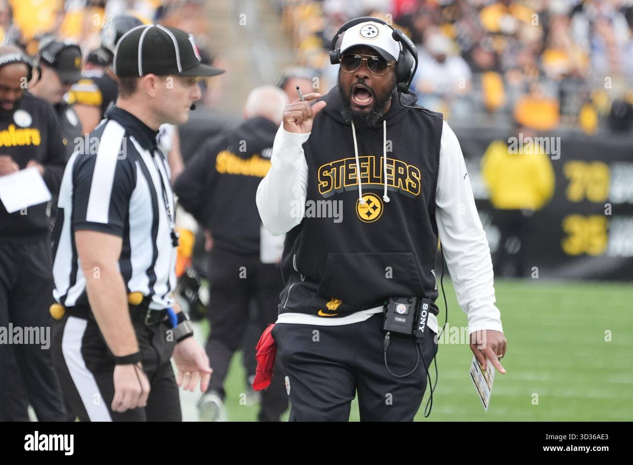 Pittsburgh Steelers head coach Mike Tomlin, right talks with line judge ...