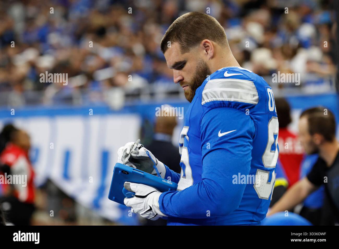Detroit Lions defensive end Pat O'Connor (95) looks at a Microsoft ...