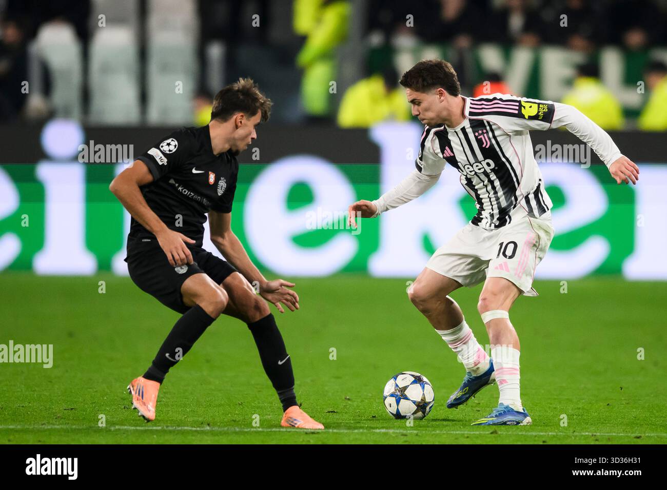 Kenan Yildiz of Juventus FC is challenged by Giorgos Vagiannidis of Sporting CP during the UEFA ...