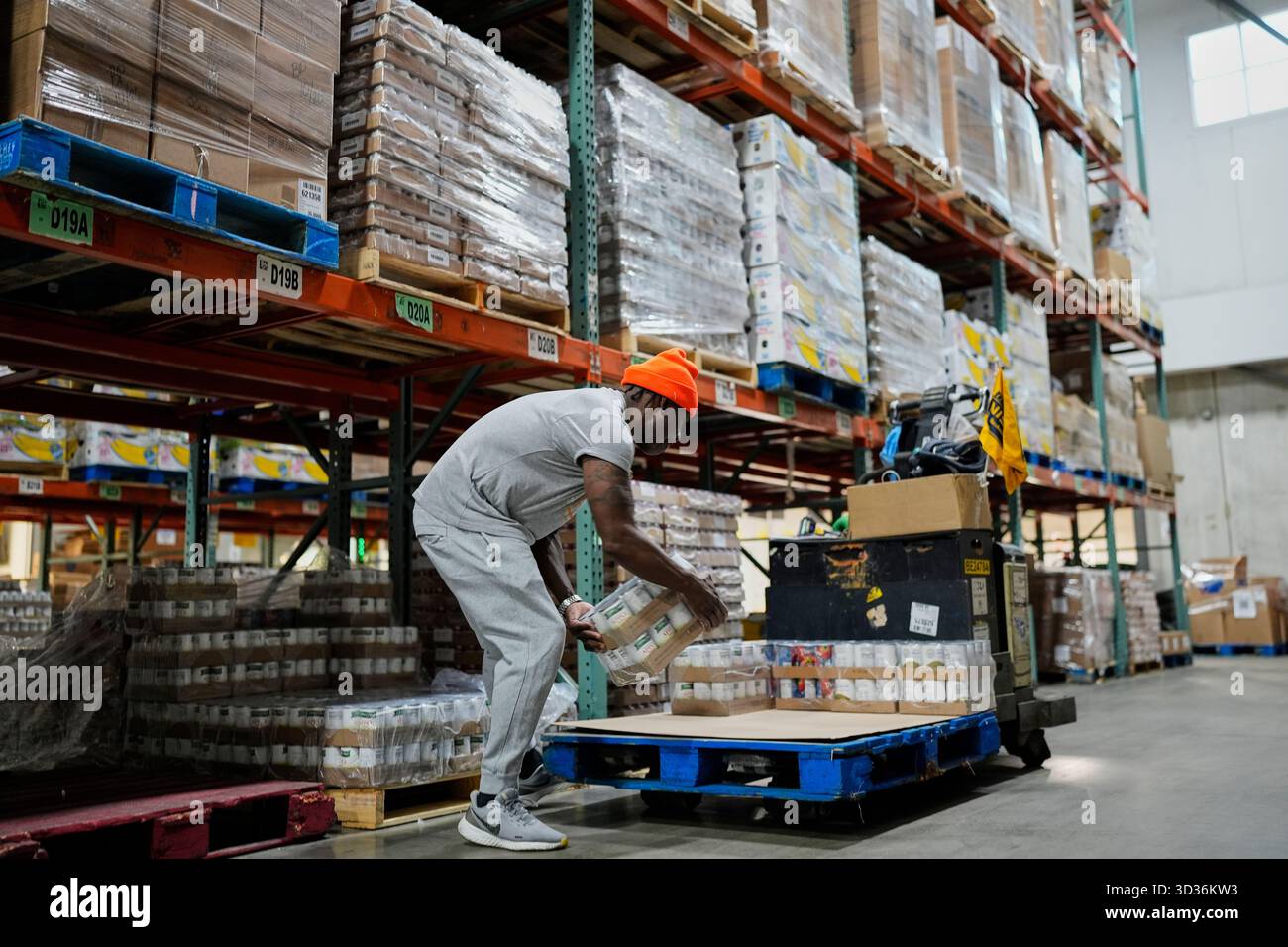 Second Harvest Food Bank employee J. Fleming loads a pallet with canned ...