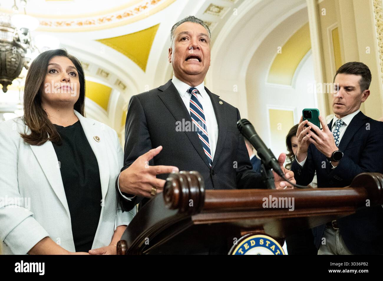 U.S. Senator Alex Padilla (D-CA), with his wife Angela Monzon on the left, speaking at a press ...