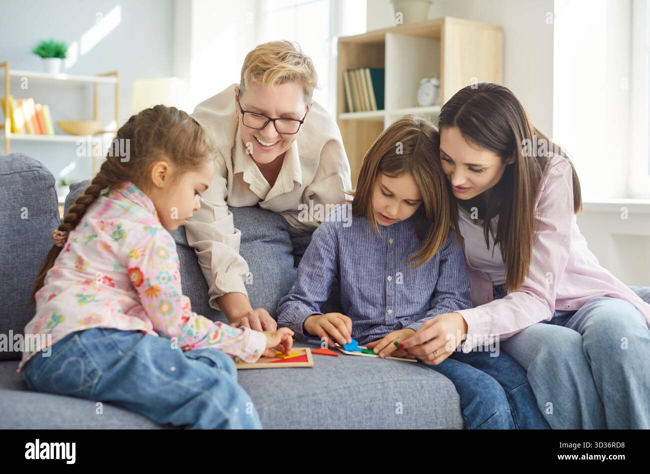 Three generation family, senior granny woman, mother, two kids sitting ...