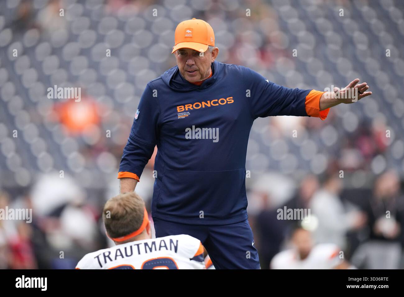 Denver Broncos head coach Sean Payton talks to Denver Broncos tight end Adam Trautman before an ...