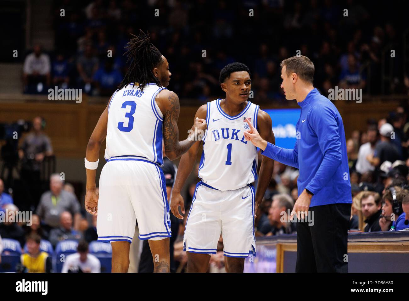 Duke head coach Jon Scheyer, right, talks with Isaiah Evans (3) and ...