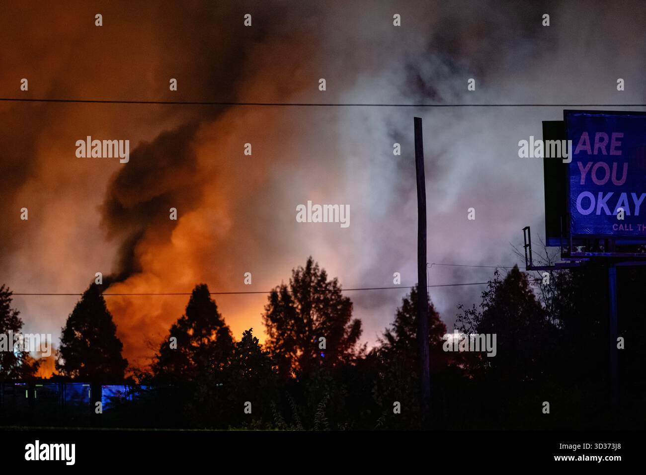 Plumes of smoke rise from the area of a plane crash at Louisville Muhammad Ali International ...